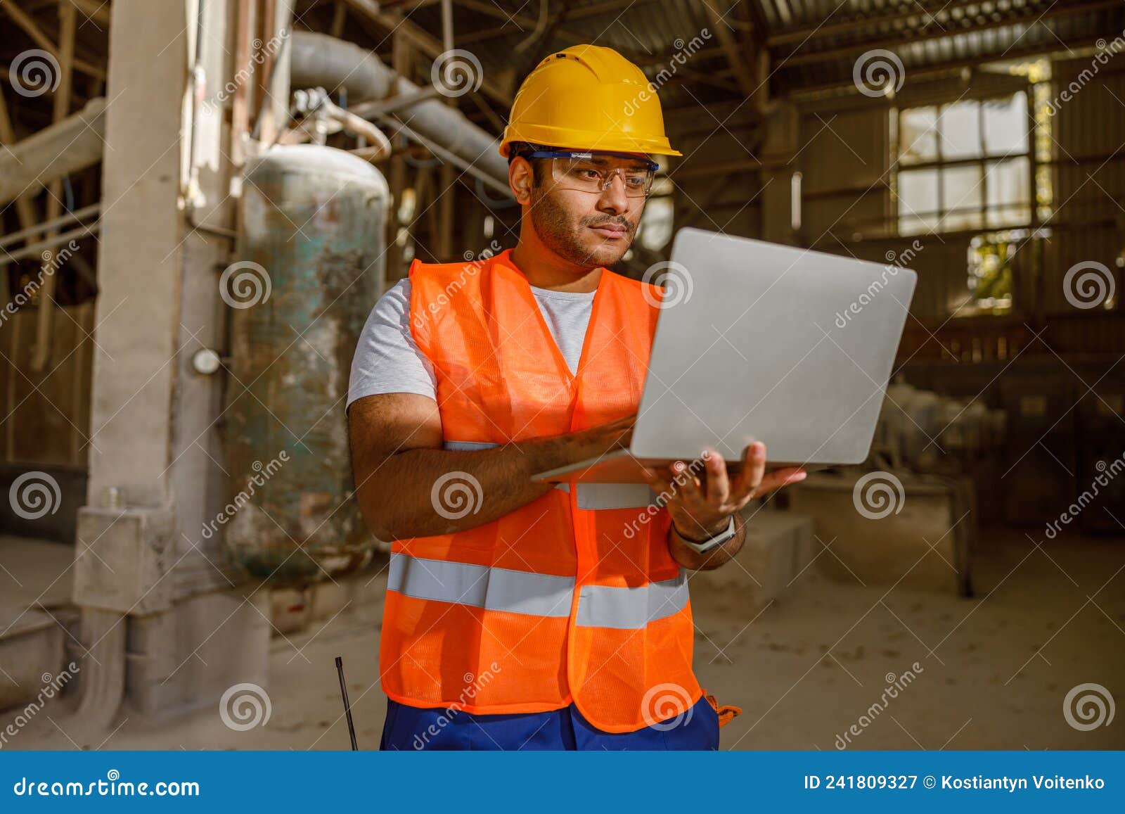 Skillful Multiethnic Engineer Working at Construction Plant Stock Image ...
