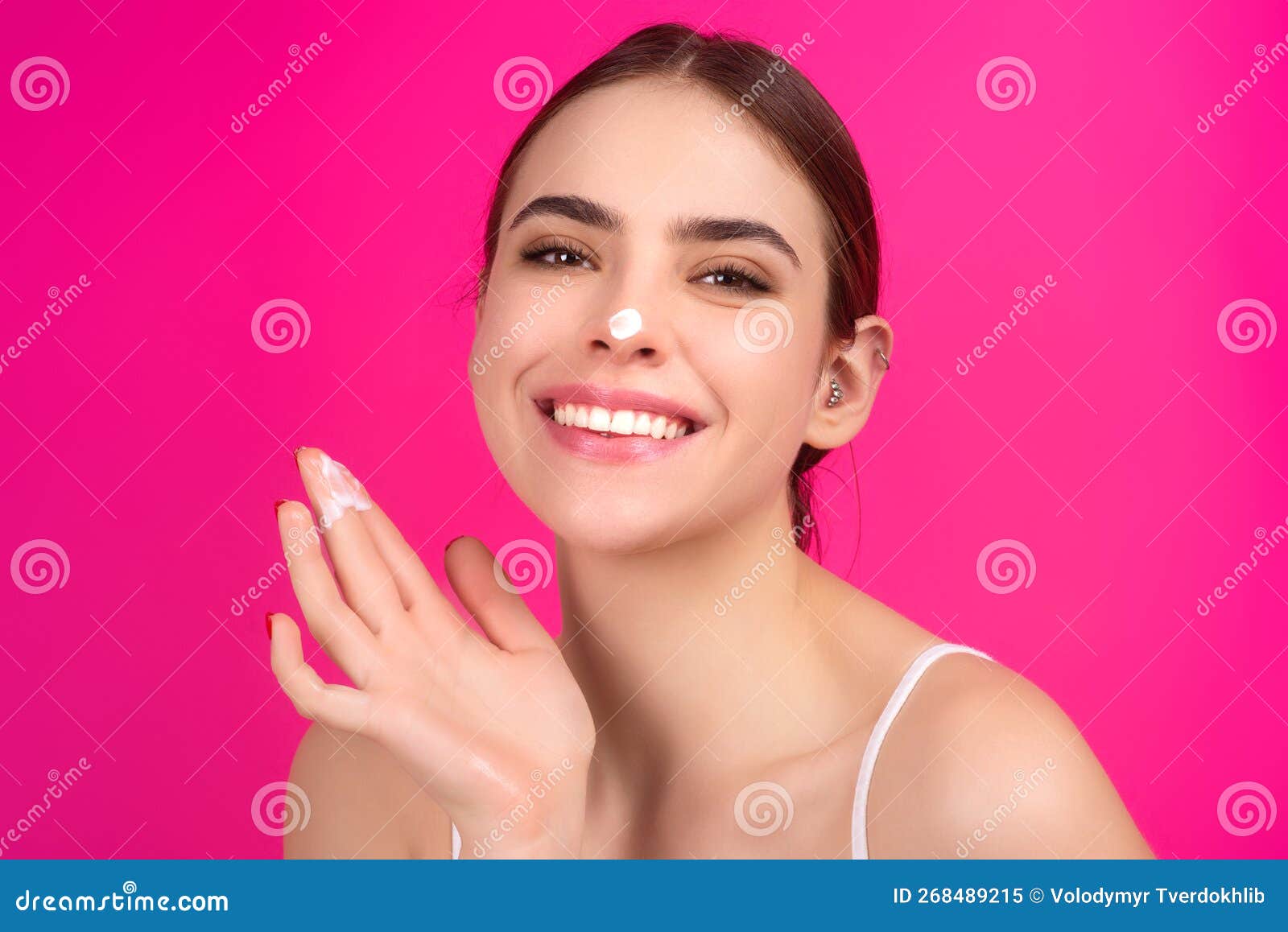 Skin Care Beauty Portrait Of A Beautiful Woman Applying Face Cream