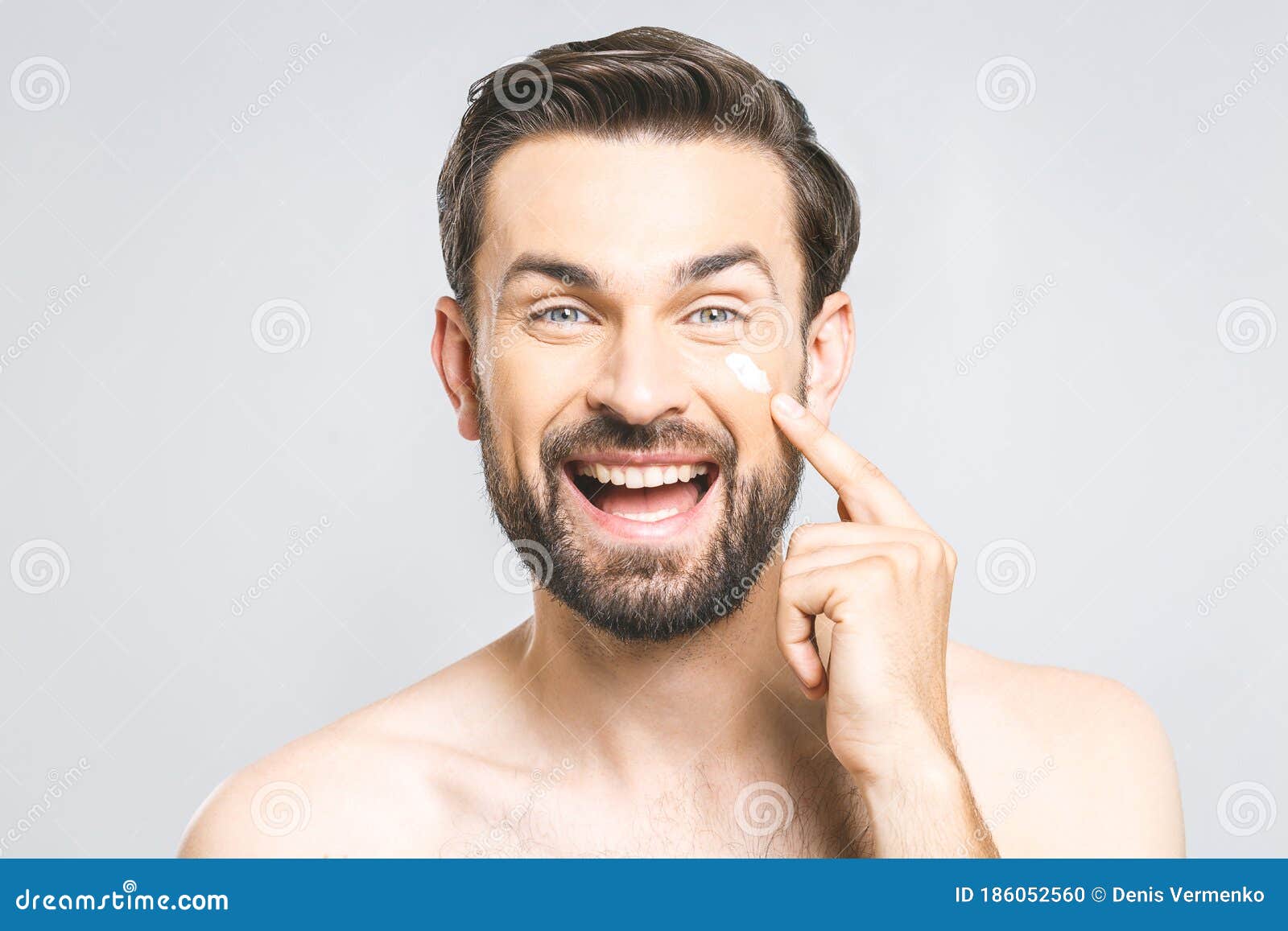 Skin Care Handsome Happy Young Shirtless Man Applying Cream At His