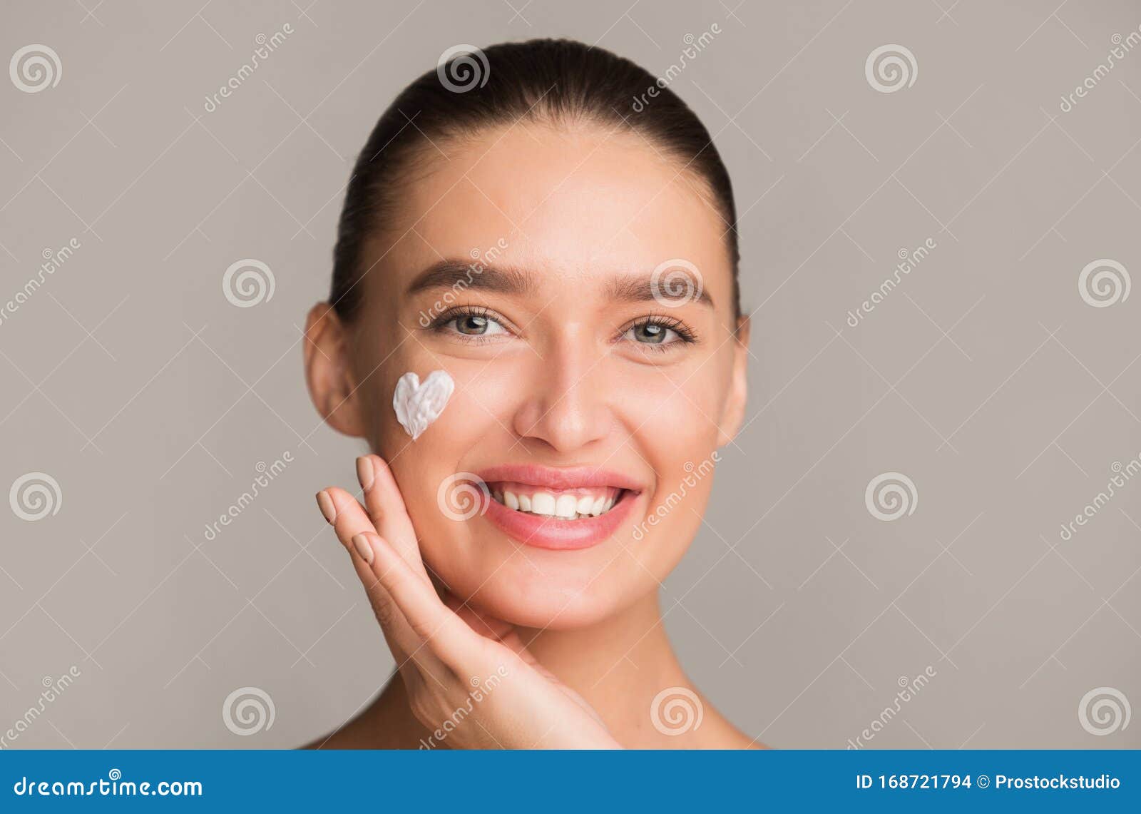 Skin Hydration Positive Girl Applying Moisturizing Cream On Cheek