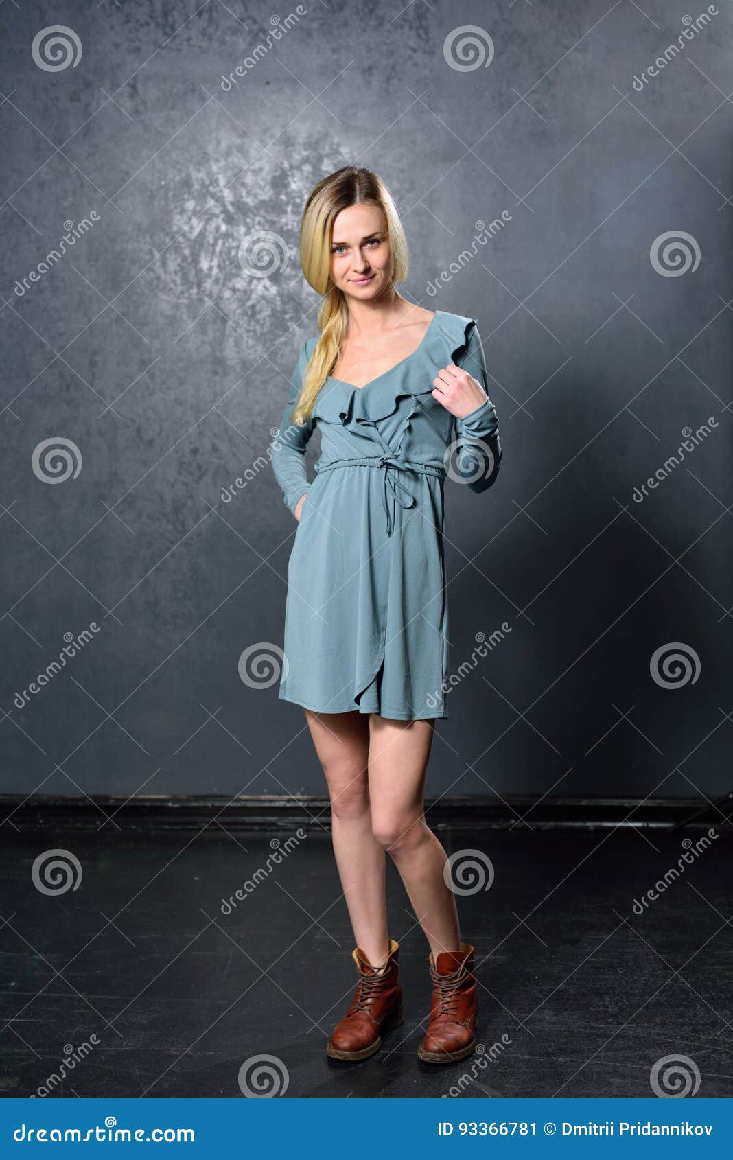 Skinny Blonde Girl Looking At The Camera And Holds Up Her Dress Stock