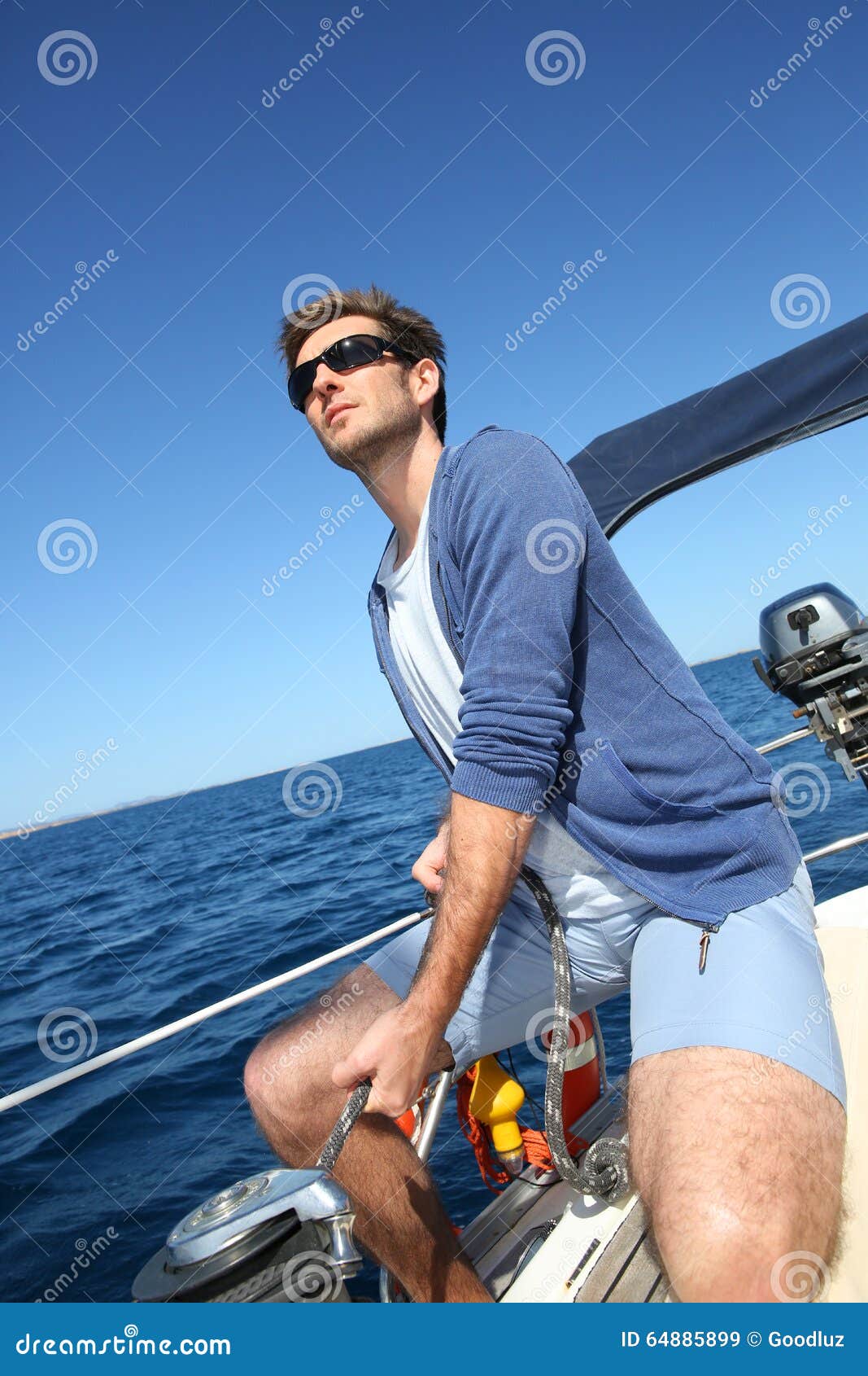 Skipper navigating boat stock image. Image of sailor - 64885899