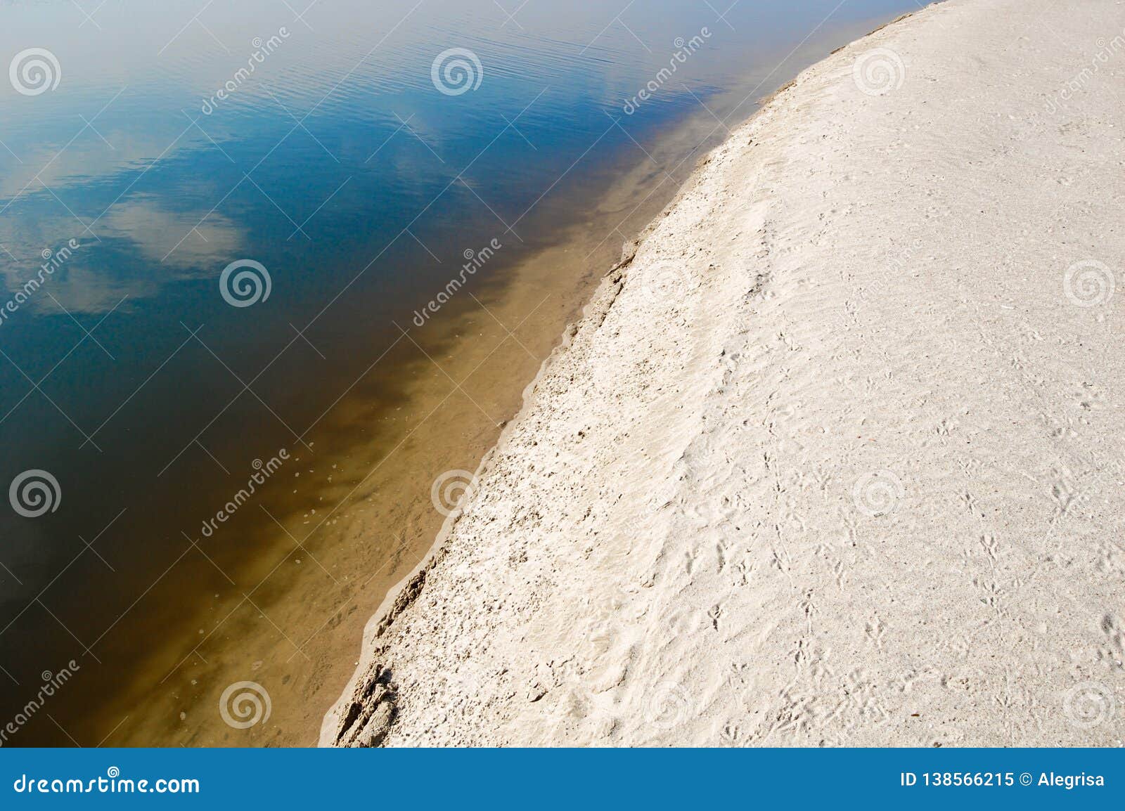 Sky and Clouds Bathe in the Sea on the Border of a Sandy Beach. the ...