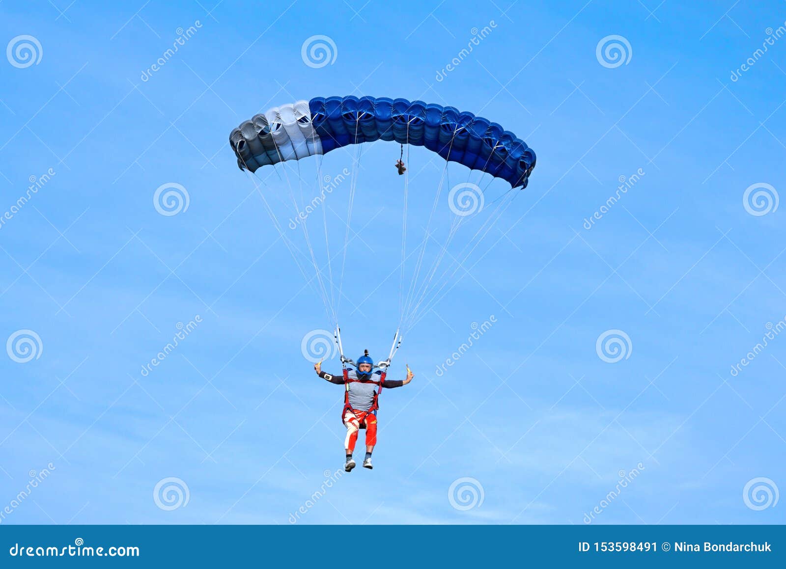 Skydiver with a Dark Blue Parachute on the Background a Blue Sky, Close ...