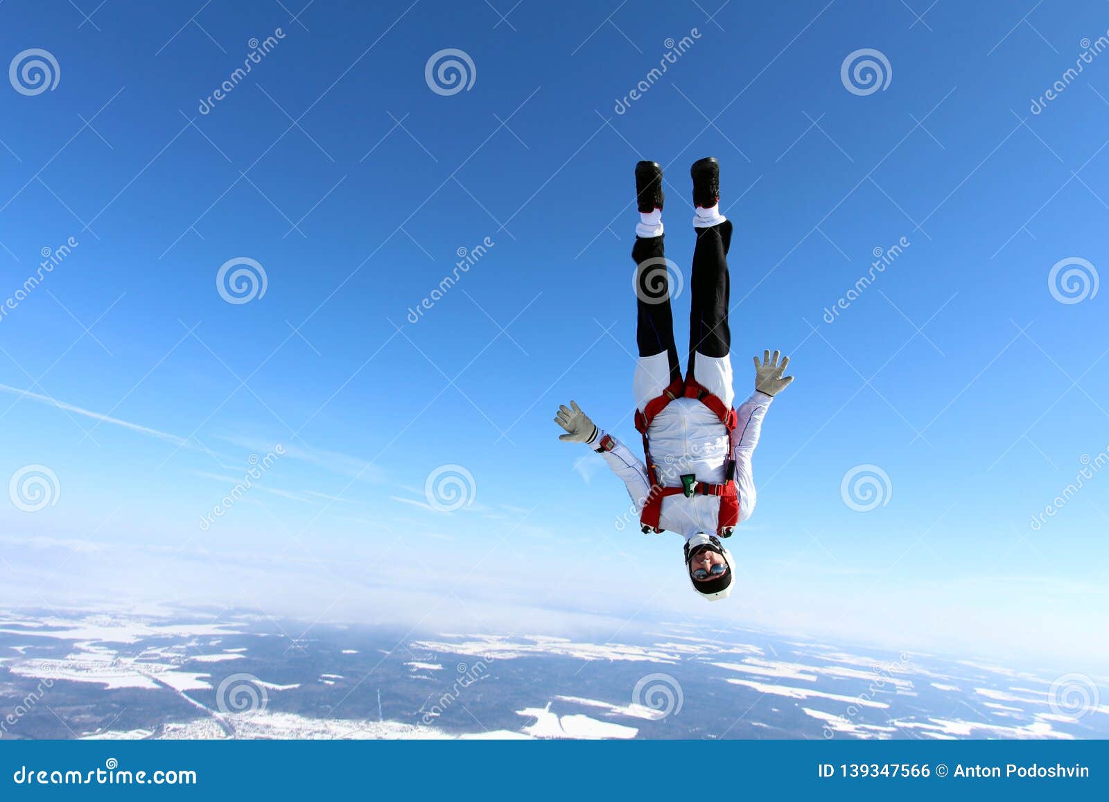 Alone Skydiver is Falling Above Snowy Ground. Stock Photo - Image of ...