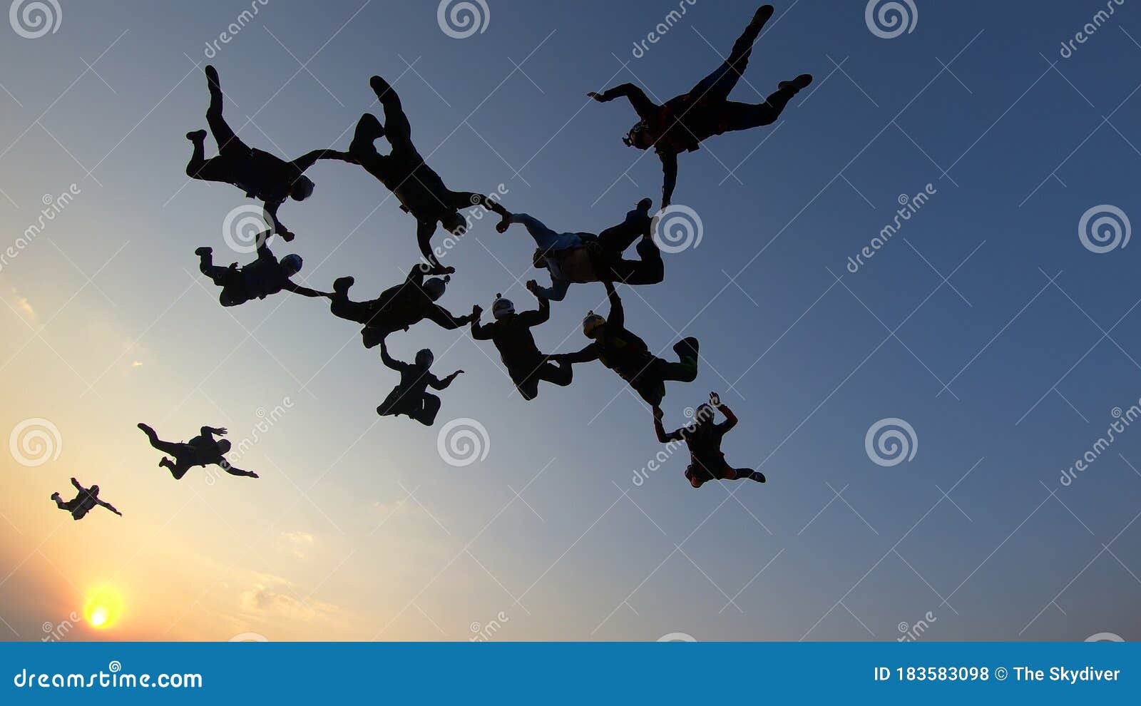 Silhouette of a Group of Skydivers Jumping at the End of the Day. Stock ...