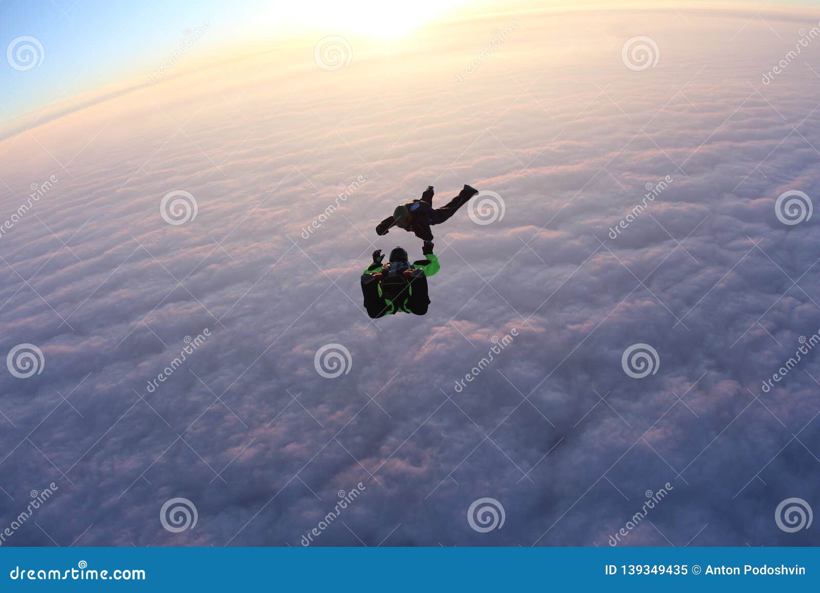 Skydiving. Sunset Jump. Skydivers are Above Pink Clouds. Stock Image ...