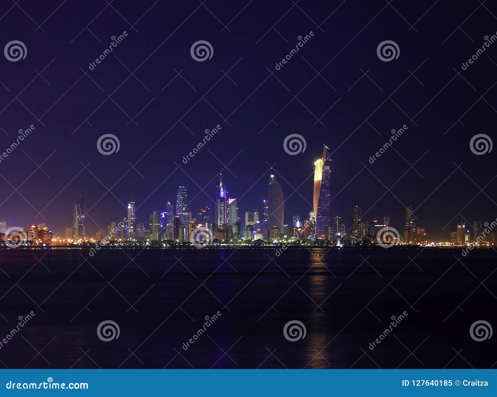 The Skyline of Kuwait City at Night Glitters with Light Stock Image ...