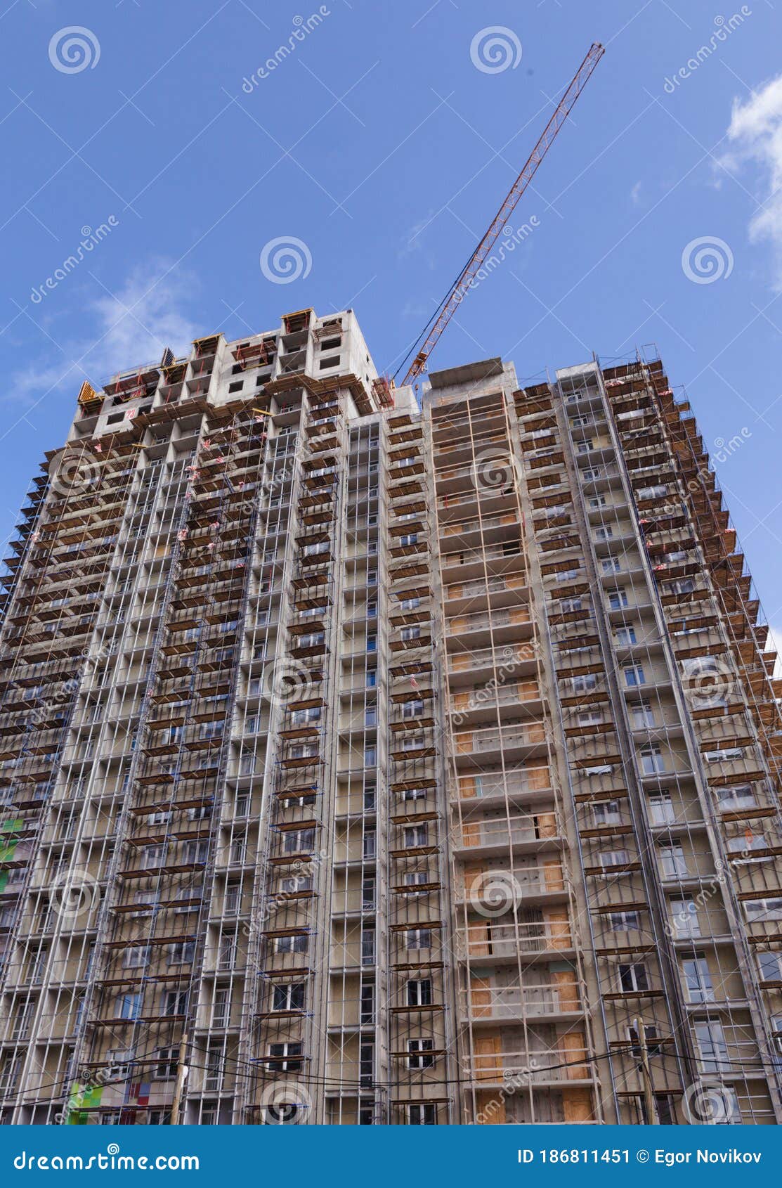 Skyscraper and Construction Crane on a Background of Blue Sky Stock ...