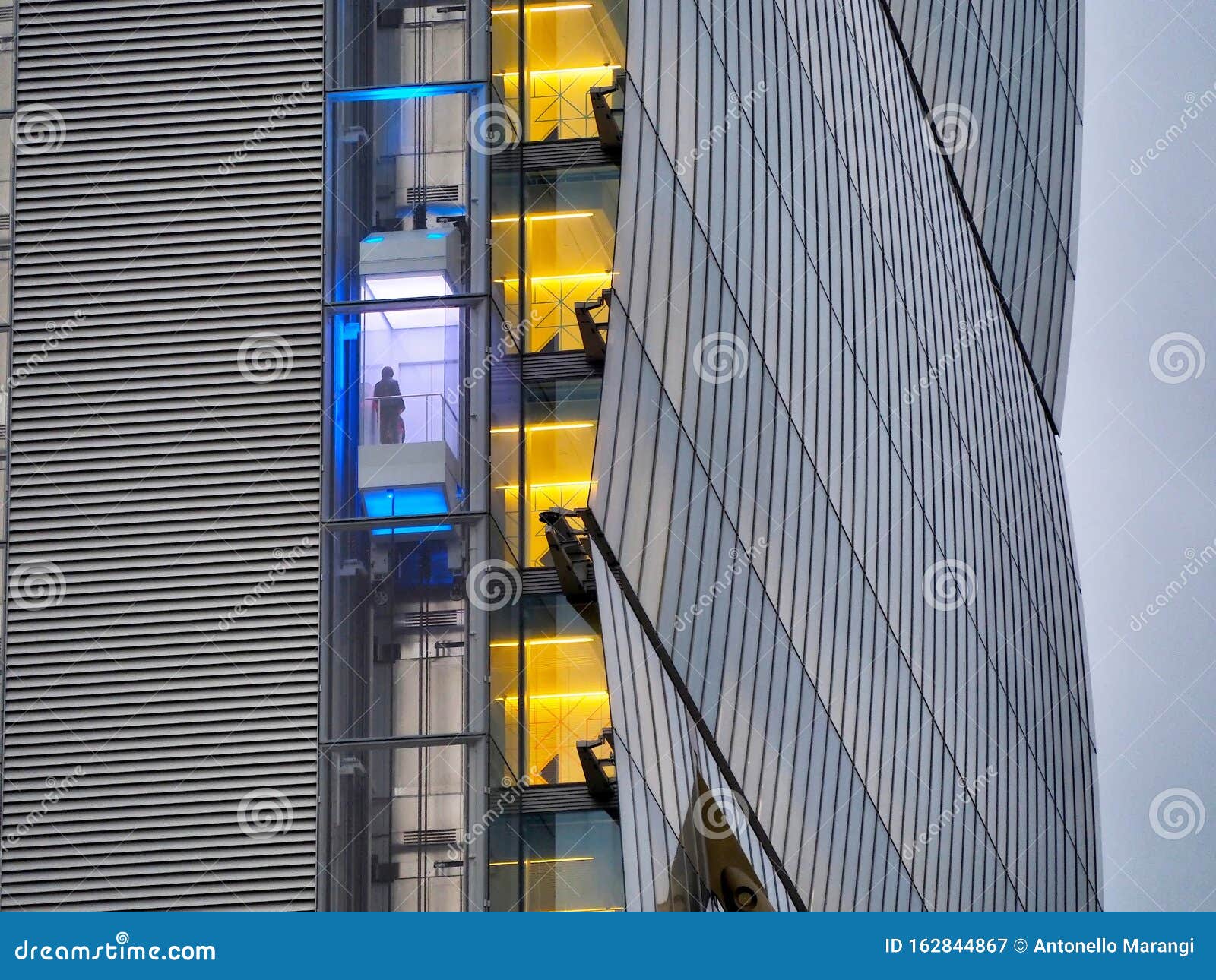 Skyscraper External Elevator with Persons Silhouette Inside Stock Image ...