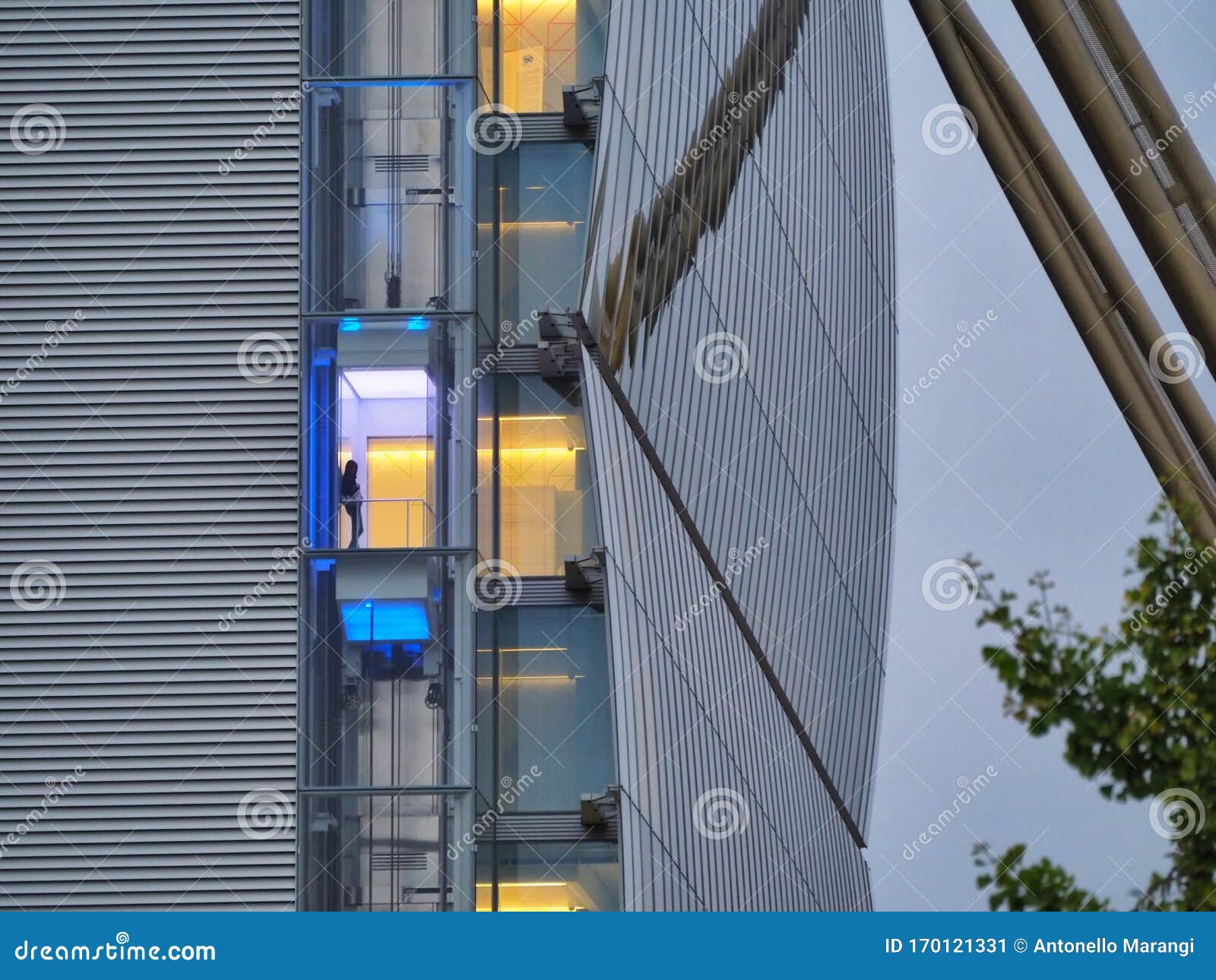 Skyscraper External Elevator with Persons Silhouette Inside Stock Image ...