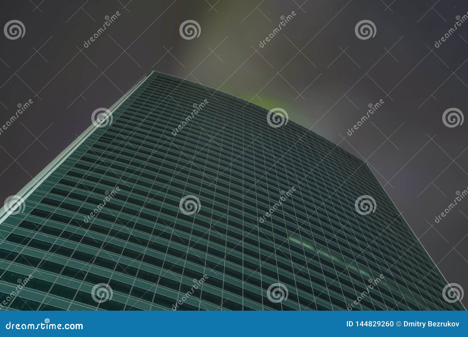Skyscraper in Fog with Glowing Windows at Night Stock Photo - Image of ...