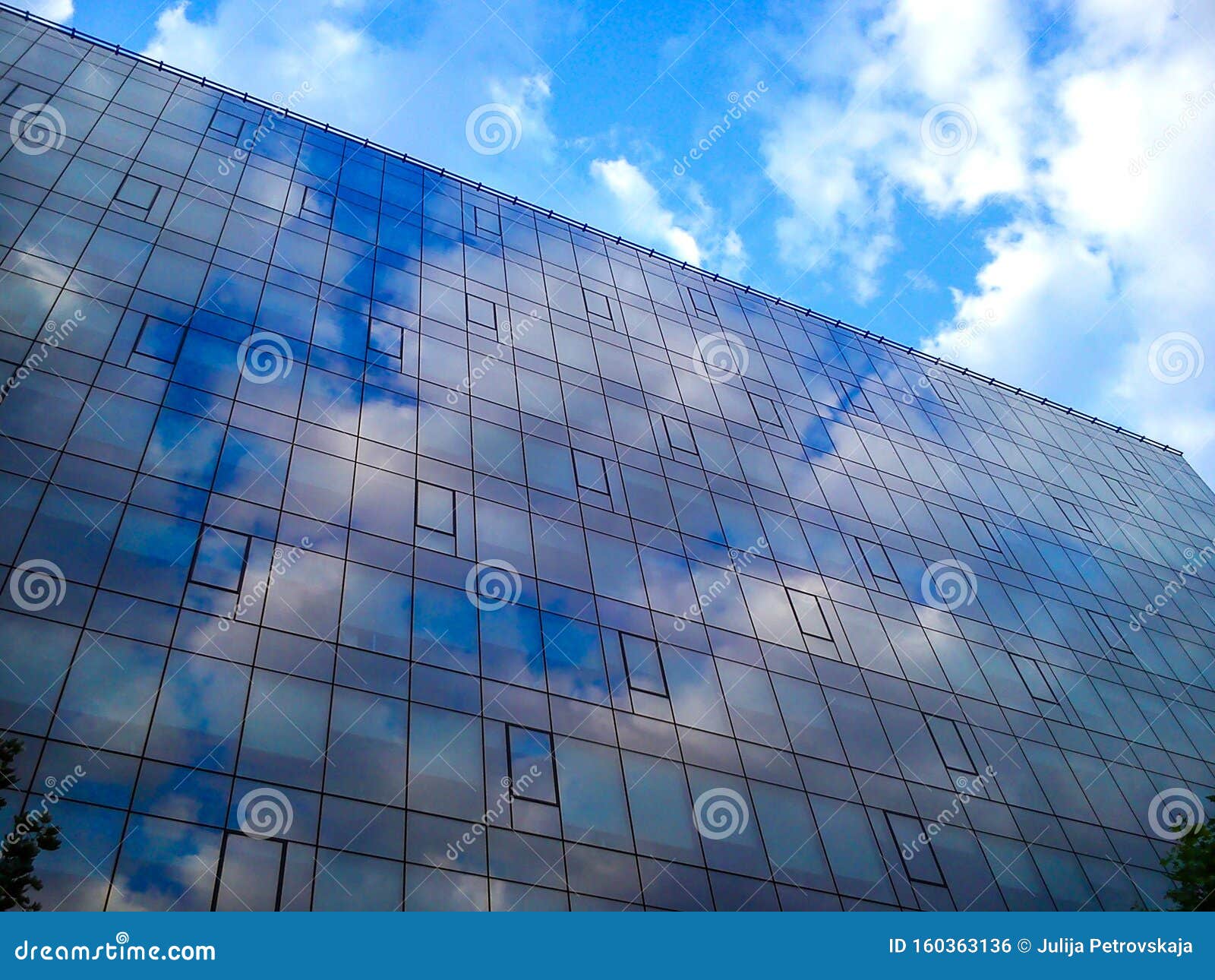 Skyscraper with Glass Walls and Windows. the Glass Reflects the Blue ...