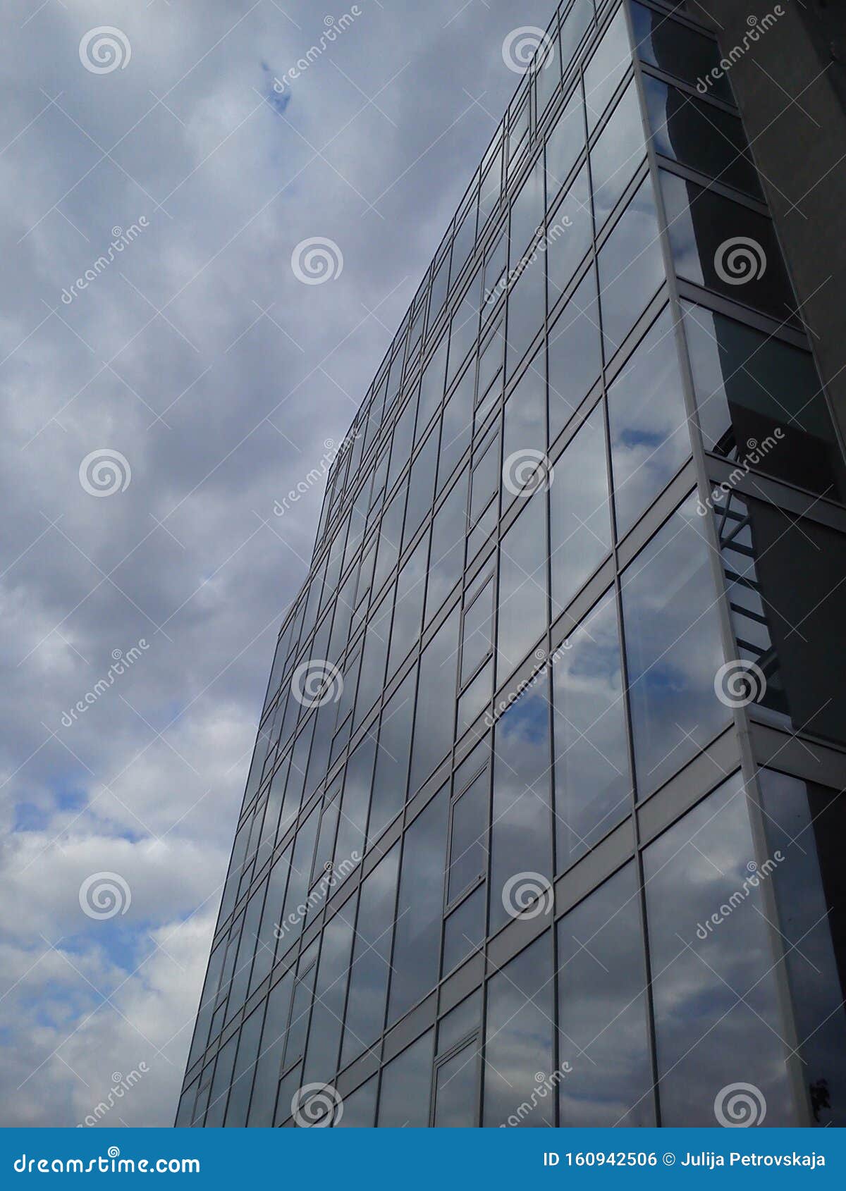 Skyscraper with Glass Walls and Windows. the Glass Reflects the Blue ...