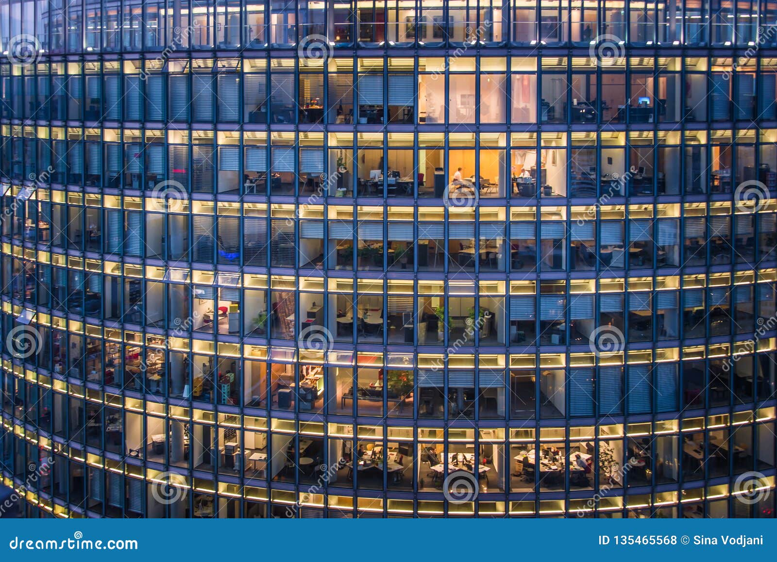 Skyscraper Office Windows and Office Worker by Night Stock Photo ...