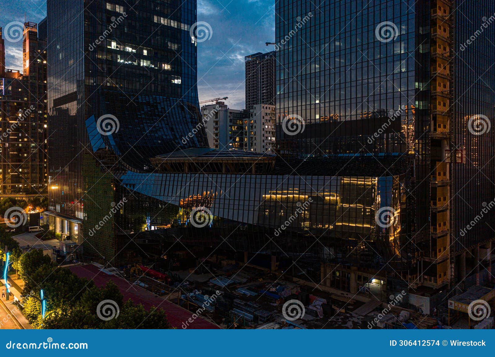 Skyscraper Under Construction in the Evening, Decorated with Glass ...