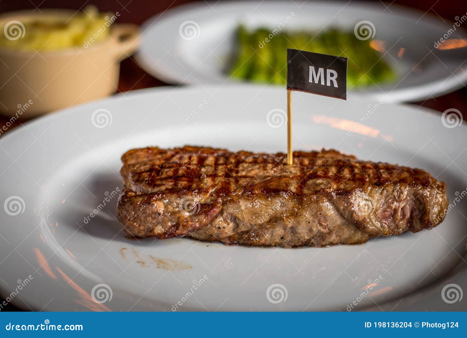 A Slab of Ribeye Beef Steak Done To Medium Rare Served on a Plate Stock ...