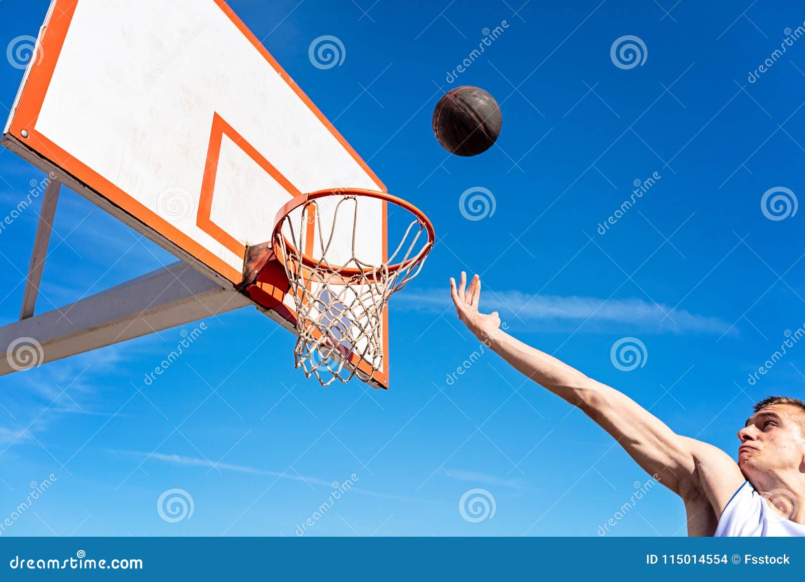 Slam Dunk. Side View of Young Basketball Player Making Slam Dunk Stock ...