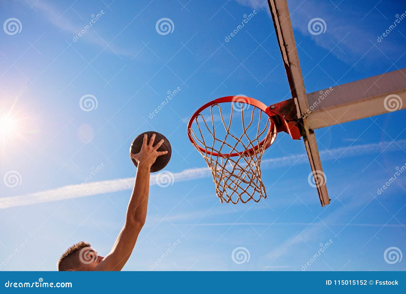 Slam Dunk. Side View of Young Basketball Player Making Slam Dunk Stock ...