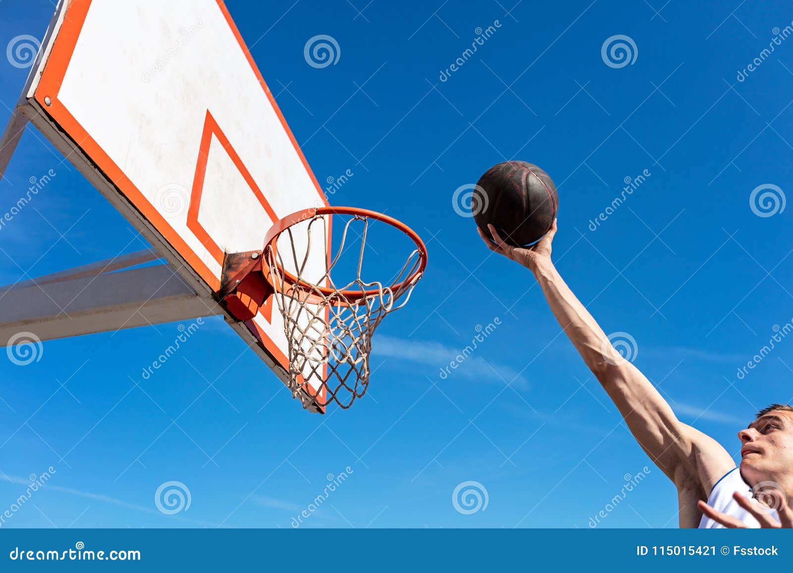 Slam Dunk. Side View of Young Basketball Player Making Slam Dunk Stock ...