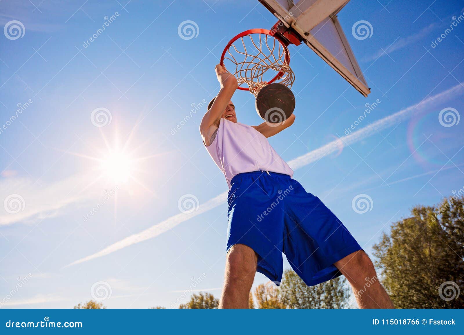 Slam Dunk. Side View of Young Basketball Player Making Slam Dunk Stock ...
