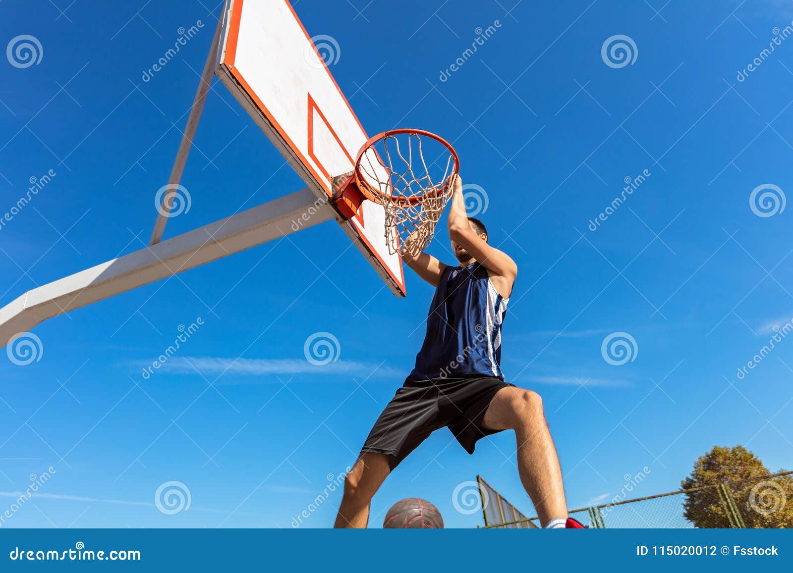 Slam Dunk. Side View of Young Basketball Player Making Slam Dunk Stock ...