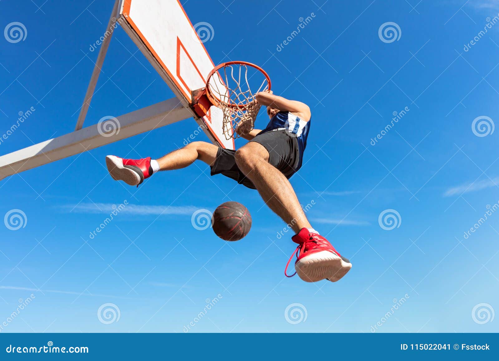 Slam Dunk. Side View of Young Basketball Player Making Slam Dunk Stock ...