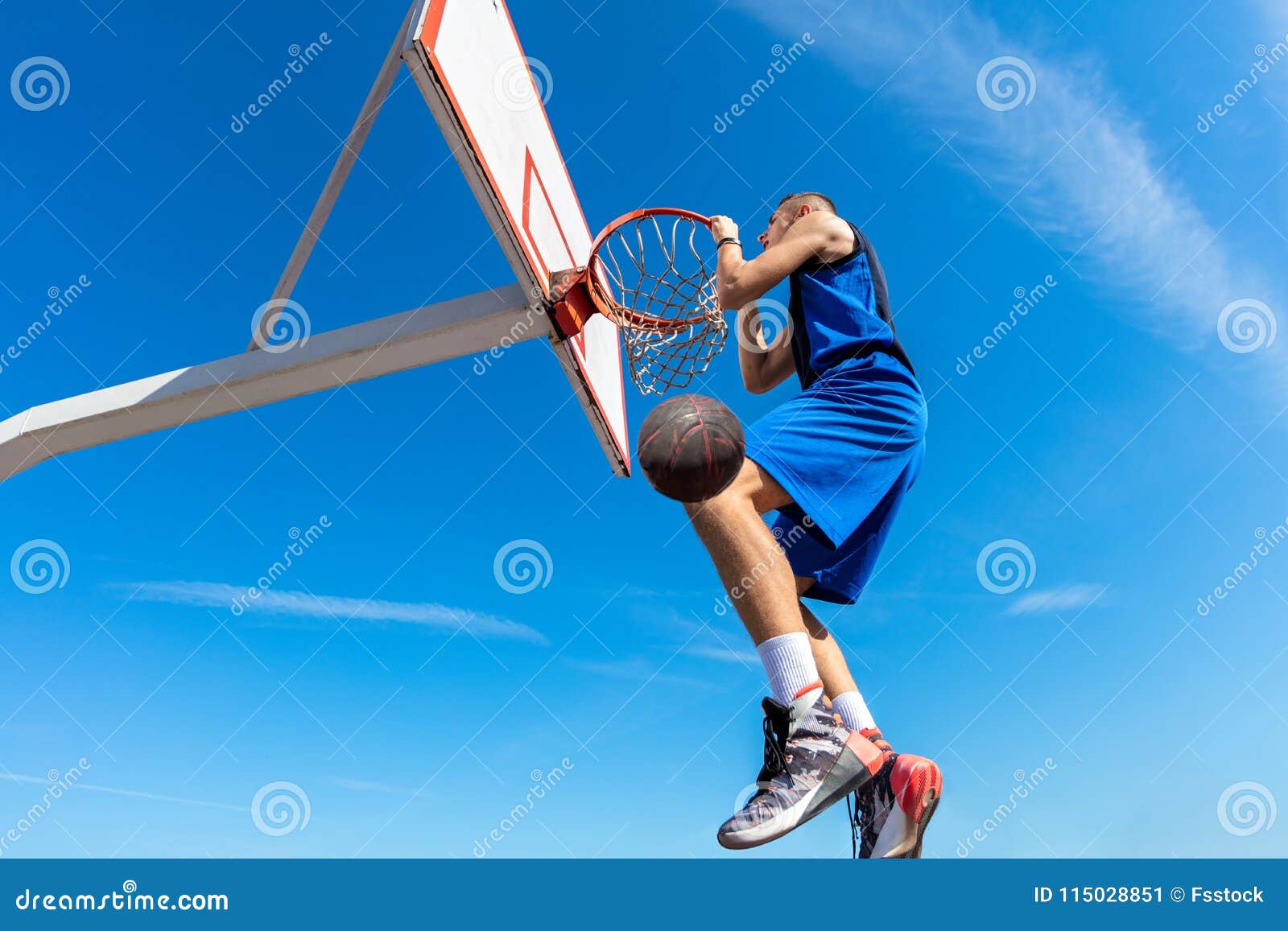 Slam Dunk. Side View of Young Basketball Player Making Slam Dunk Stock ...