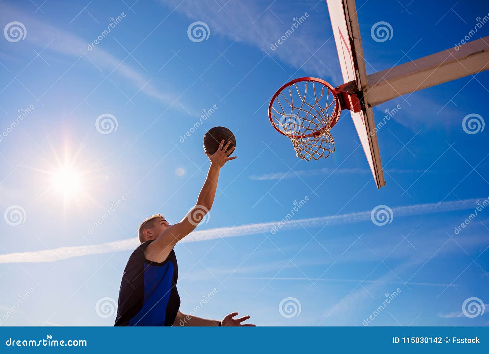Slam Dunk. Side View of Young Basketball Player Making Slam Dunk Stock ...