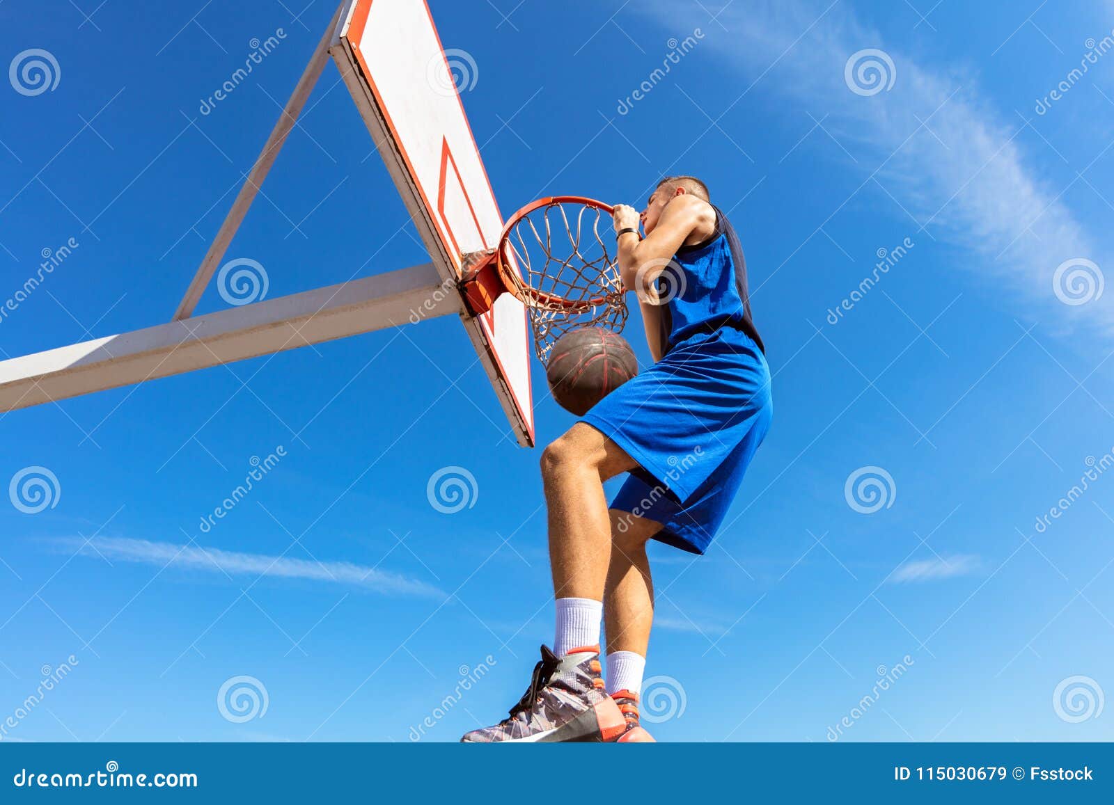 Slam Dunk. Side View of Young Basketball Player Making Slam Dunk Stock ...