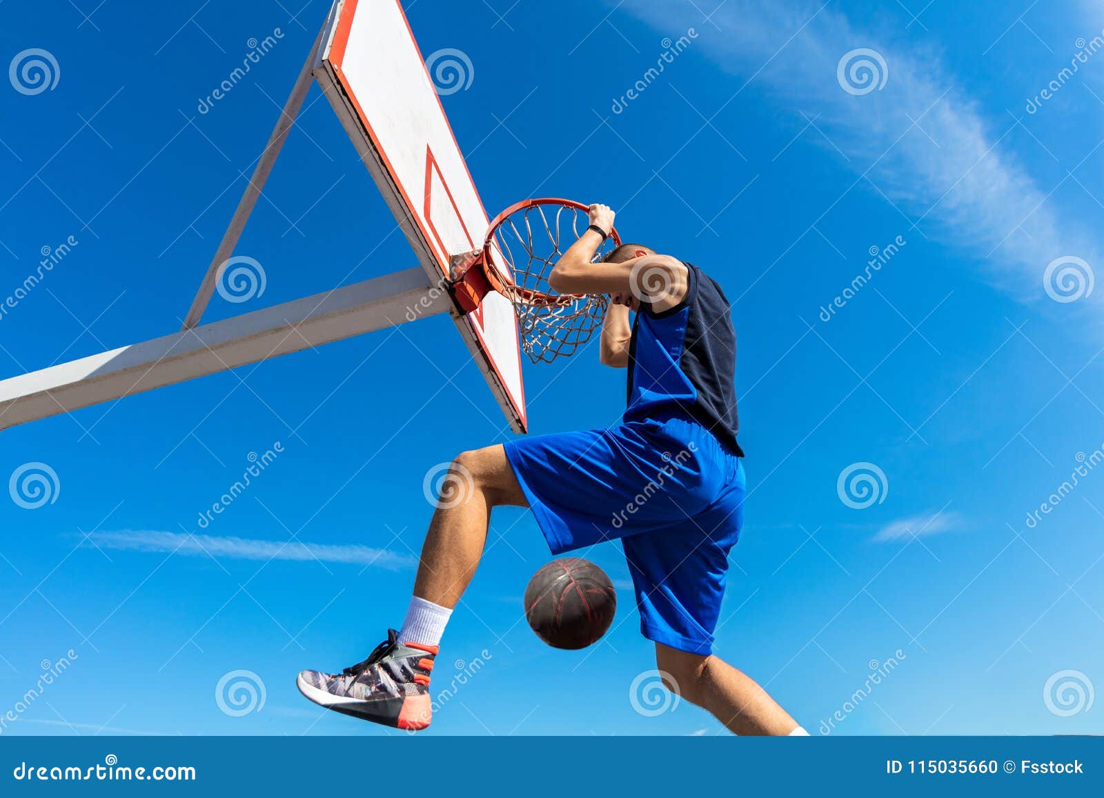 Slam Dunk. Side View of Young Basketball Player Making Slam Dunk Stock ...