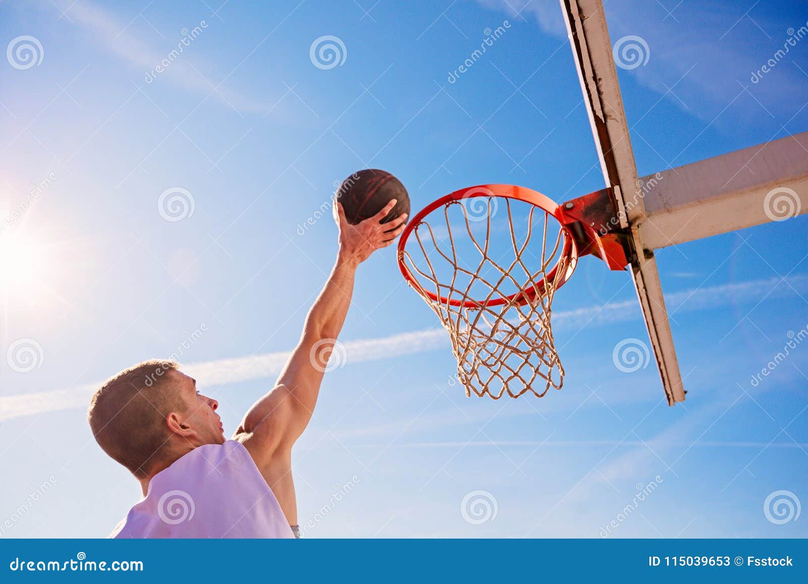 Slam Dunk. Side View of Young Basketball Player Making Slam Dunk Stock ...