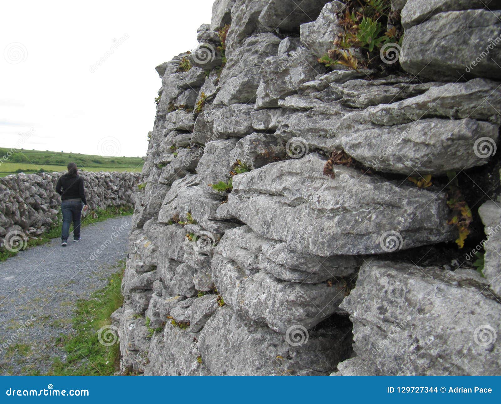 A Slate Rubble Wall with a Lady Wondering by Stock Photo - Image of ...