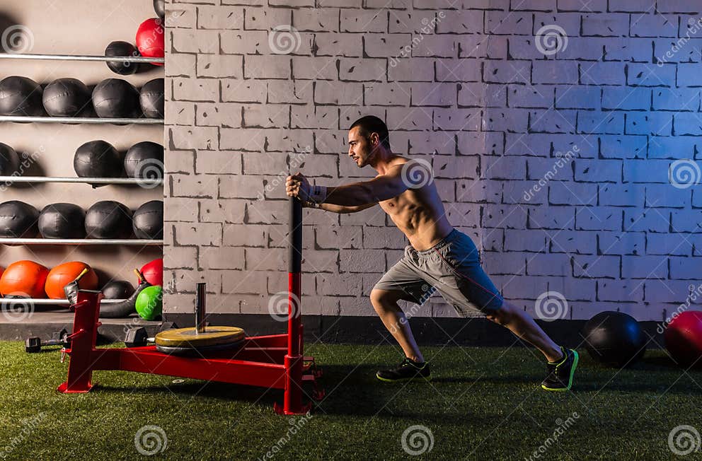 Sled Push Man Pushing Weights Workout Stock Photo - Image of building ...