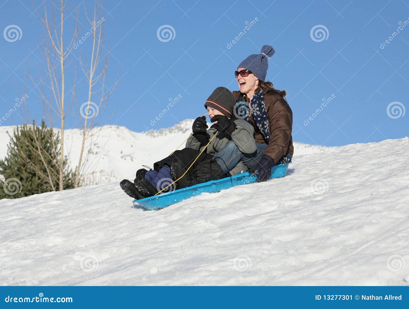 Sledding together stock image. Image of hill, moving - 13277301
