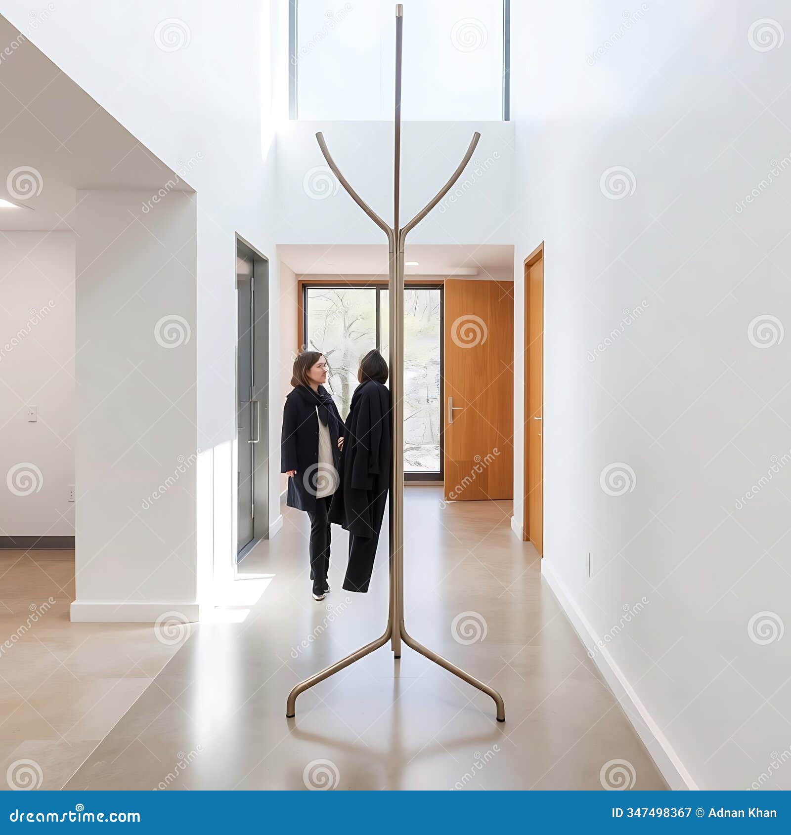 A Sleek Metallic Coat Rack with Angular Design in a Contemporary Office ...