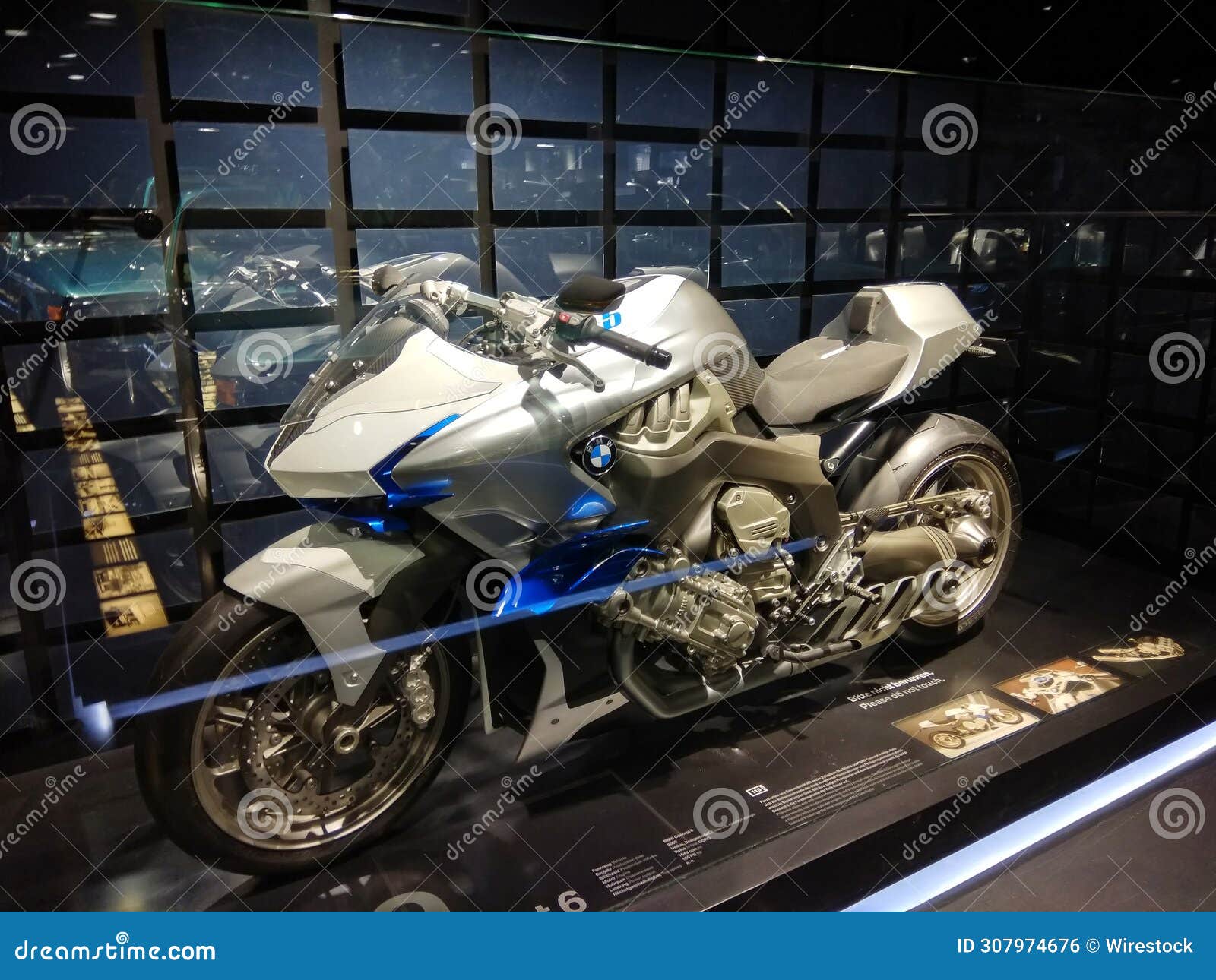 A Silver Motorcycle on Display Behind Glass in a Display Case Editorial ...