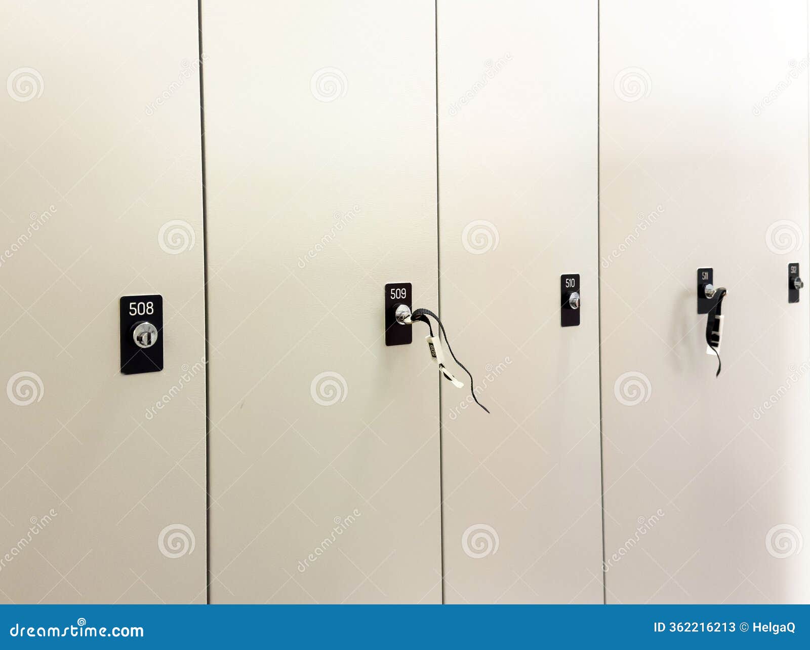 Sleek White Locker Doors with Numbered Locks and Hanging Wires Stock ...