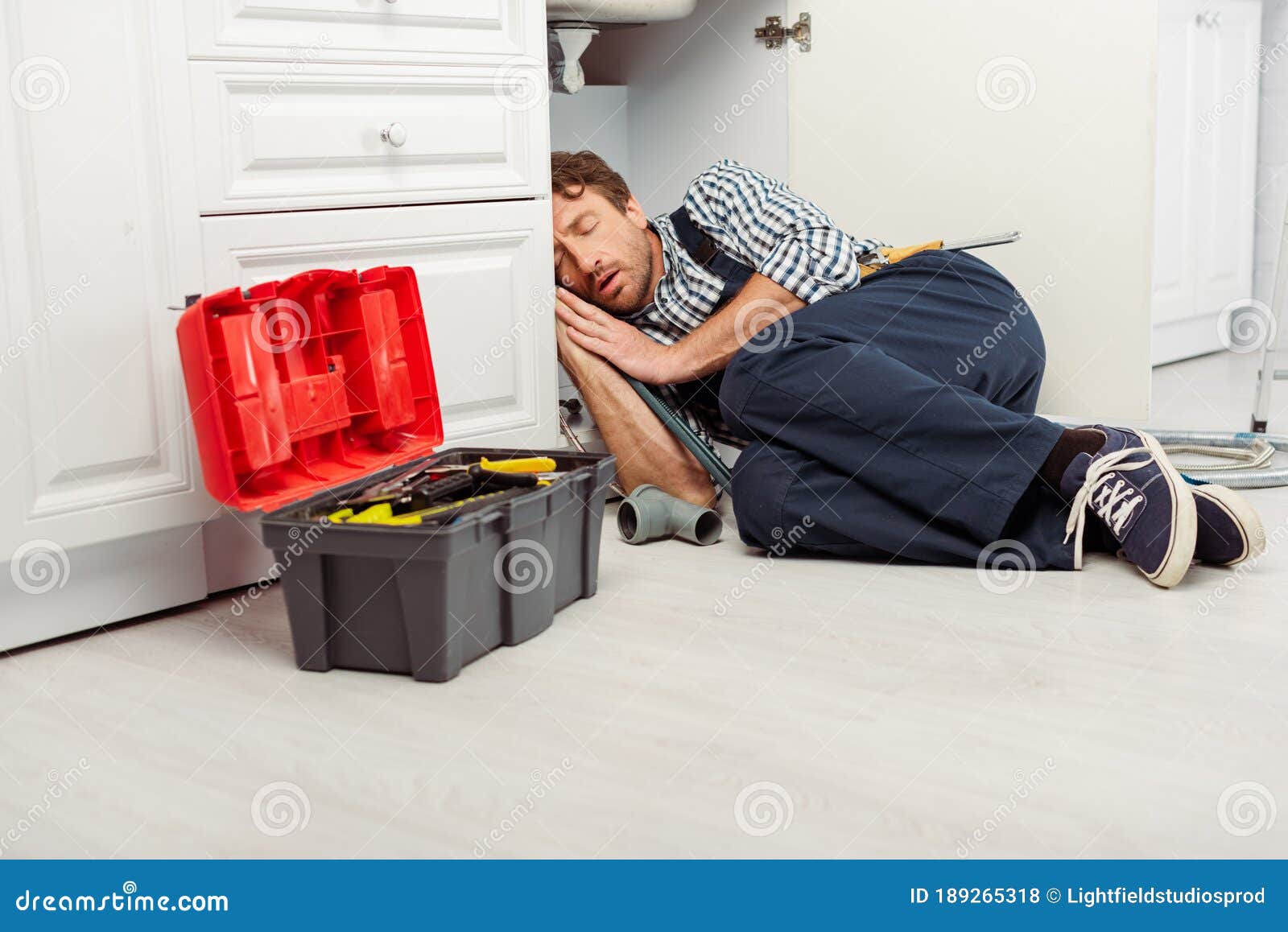 Plumber Sleeping on Floor Near Toolbox Stock Photo - Image of work ...