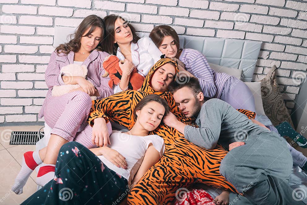 Sleeping Group of Young People in a Bad. Stock Photo - Image of ...