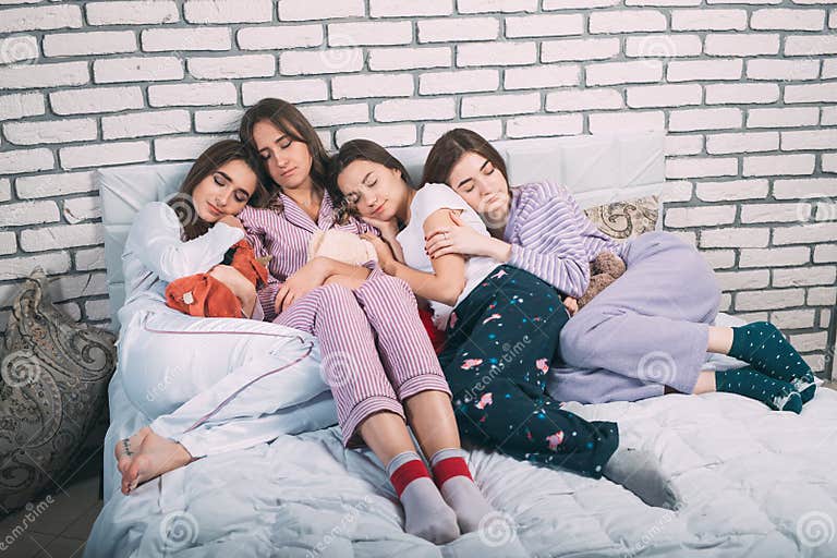 Sleeping Group of Young People on the Bed. Stock Photo - Image of ...