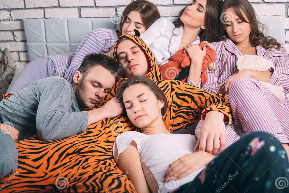 Sleeping Group of Young People on the Bed. Stock Photo - Image of ...