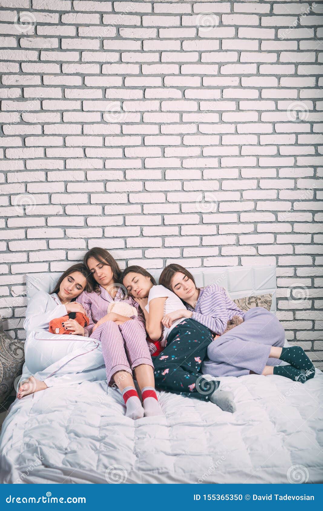 Sleeping Group of Young People on the Bed. Stock Photo - Image of ...
