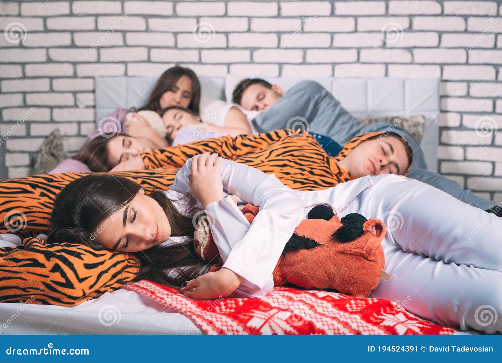 Sleeping Group of Young People on the Bed. Stock Image - Image of relax ...