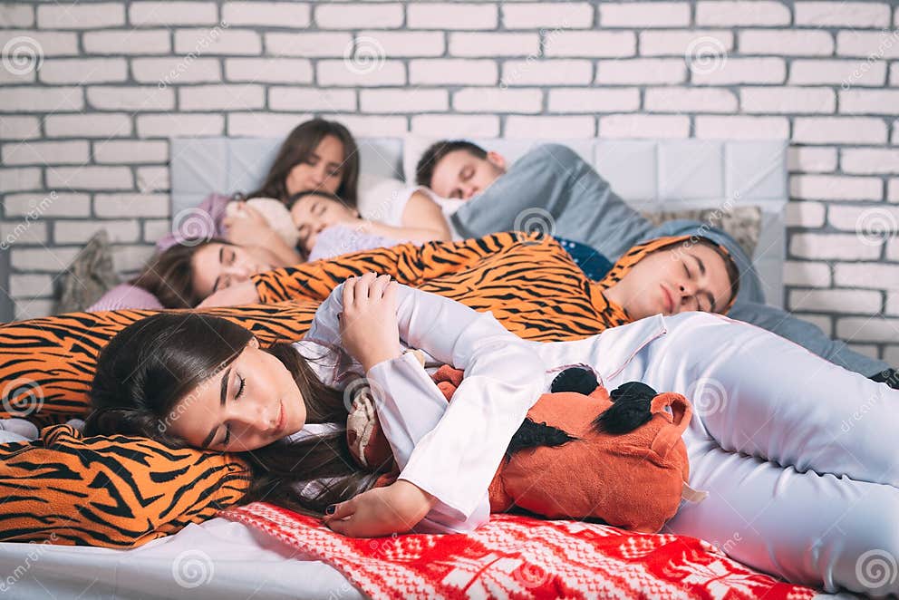 Sleeping Group of Young People on the Bed. Stock Image - Image of relax ...
