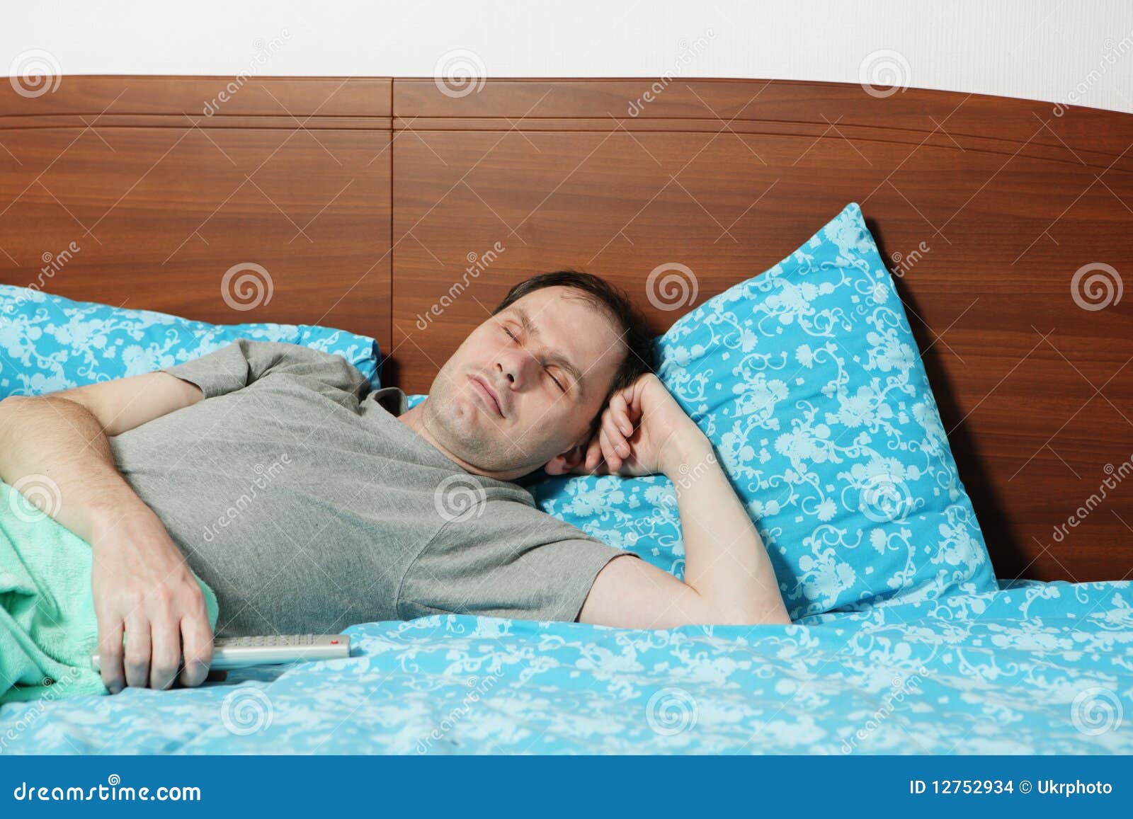 Sleeping man in bed stock photo. Image of shirt, watching - 12752934