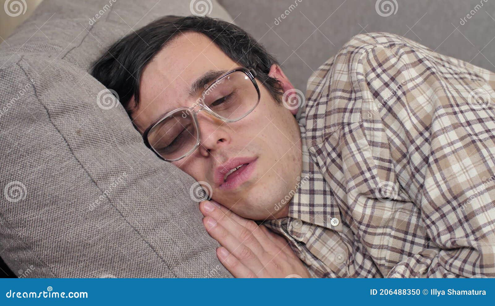 Sleeping nerd on the sofa stock footage. Video of sleep - 206488350