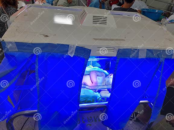 Sleeping Newborn in a Blue Incubator : a Premature or Premature Baby ... Sleeping Newborn in a Blue Incubator : a Premature or Premature Baby ...