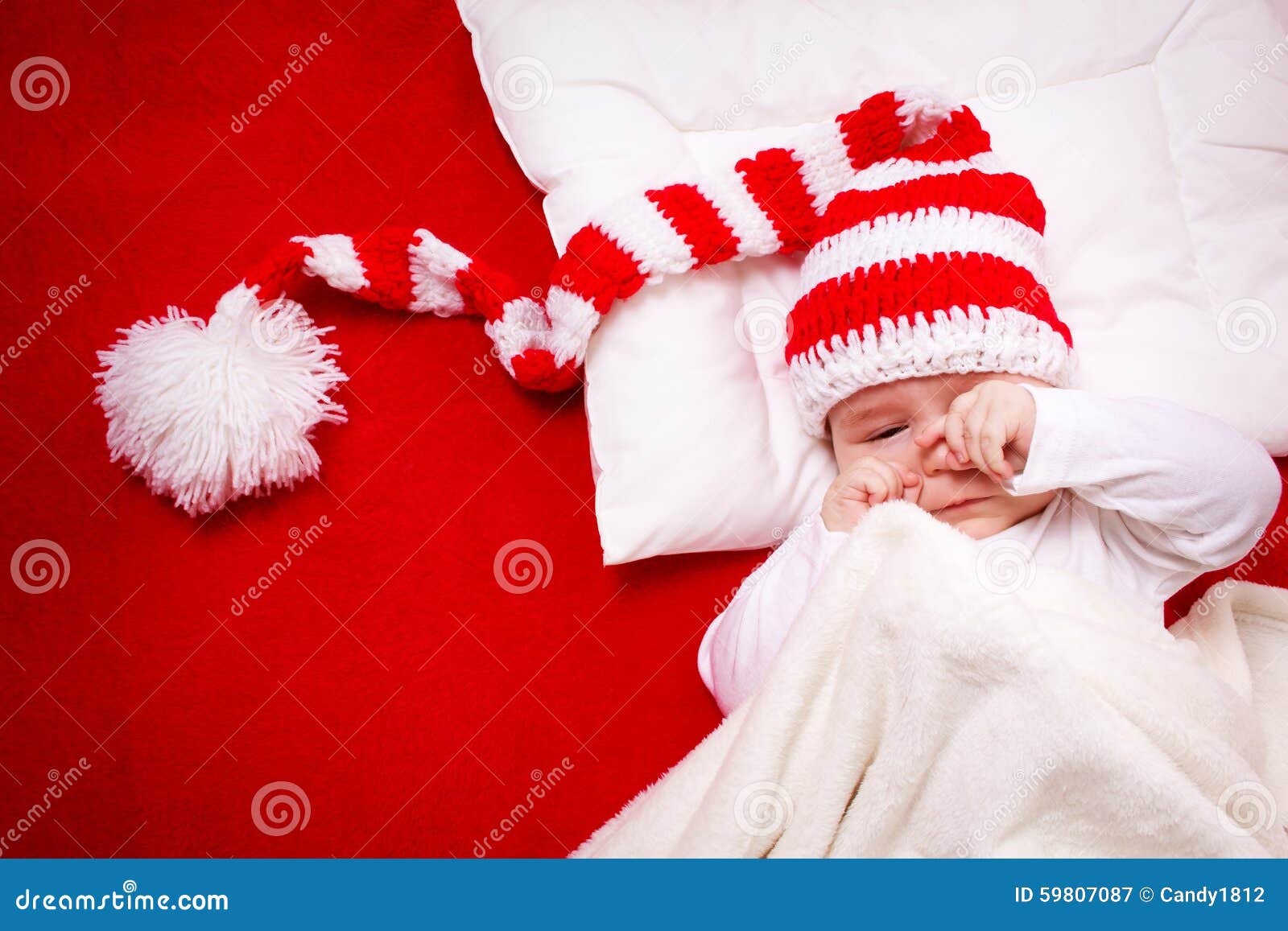 Sleepy baby on red blanket stock image. Image of cute - 59807087