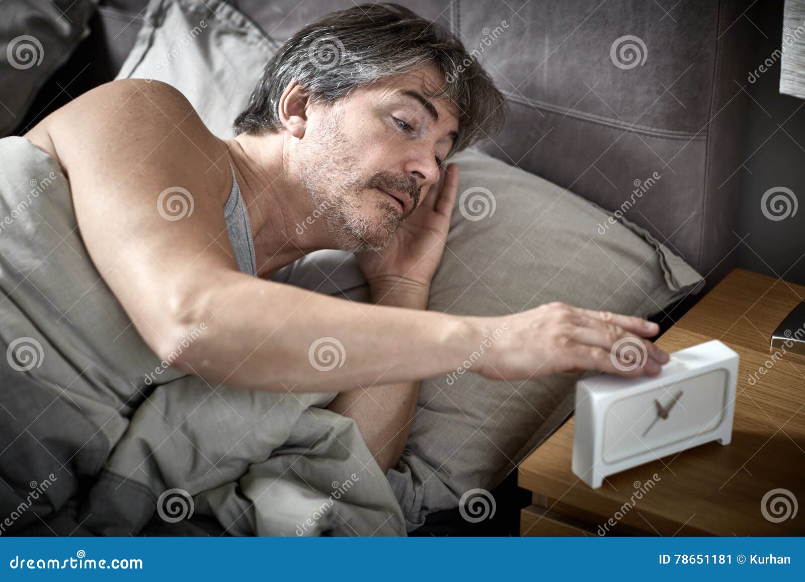 Sleepy man in bed wake up. stock image. Image of lifestyle - 78651181